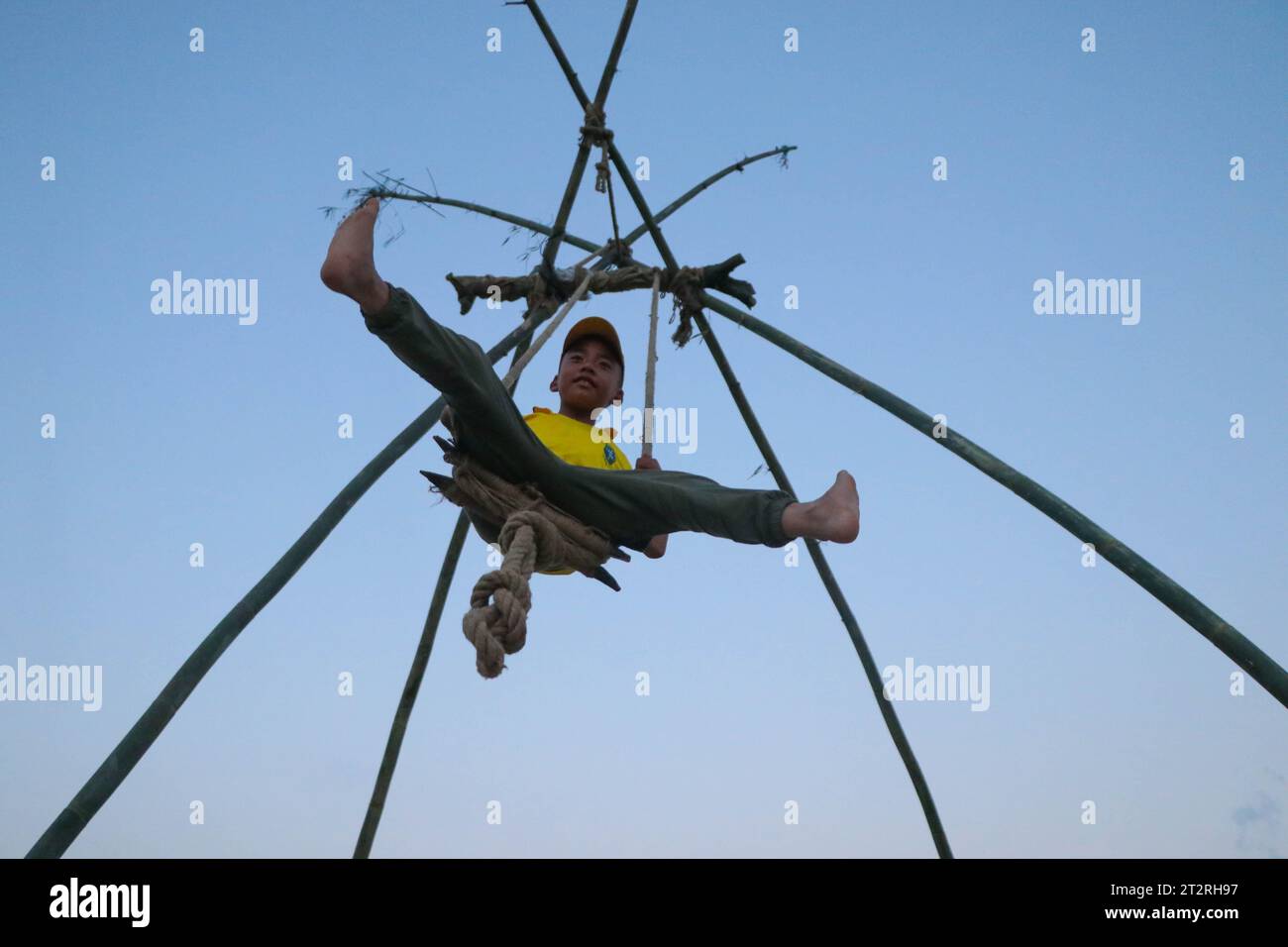 Kathmandu, Nepal. 20th Oct, 2023. A boy enjoys traditional bamboo swing ...