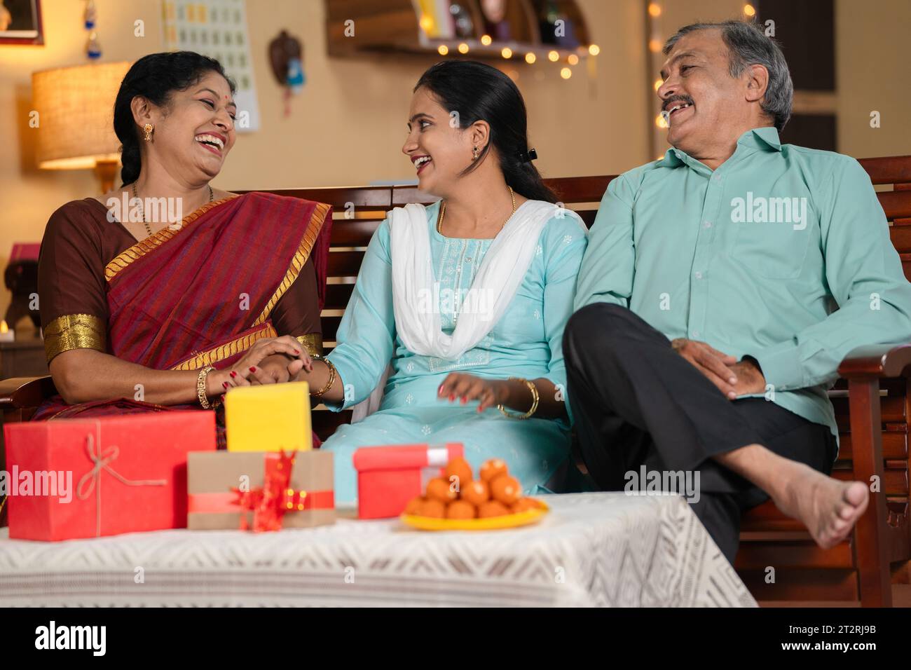 Happy 50s parents spending time with daughter during diwali festival ...