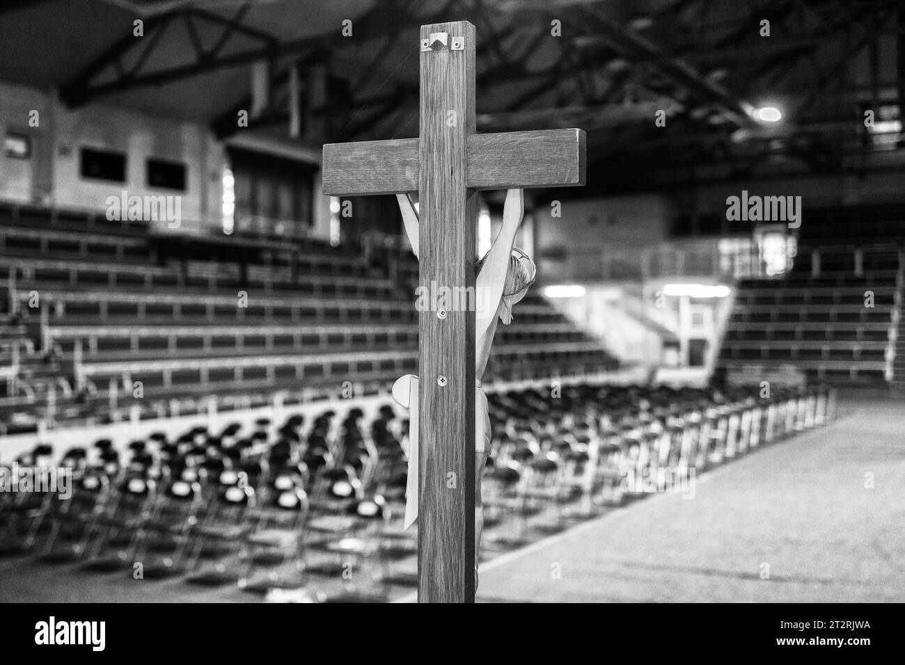 Statue of Jesus Christ on cross from behind and empty seats at ...