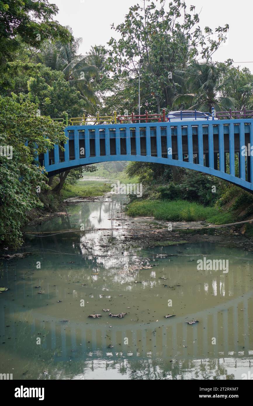 river with a pedestrian bridge over it, sky background with a wide ...