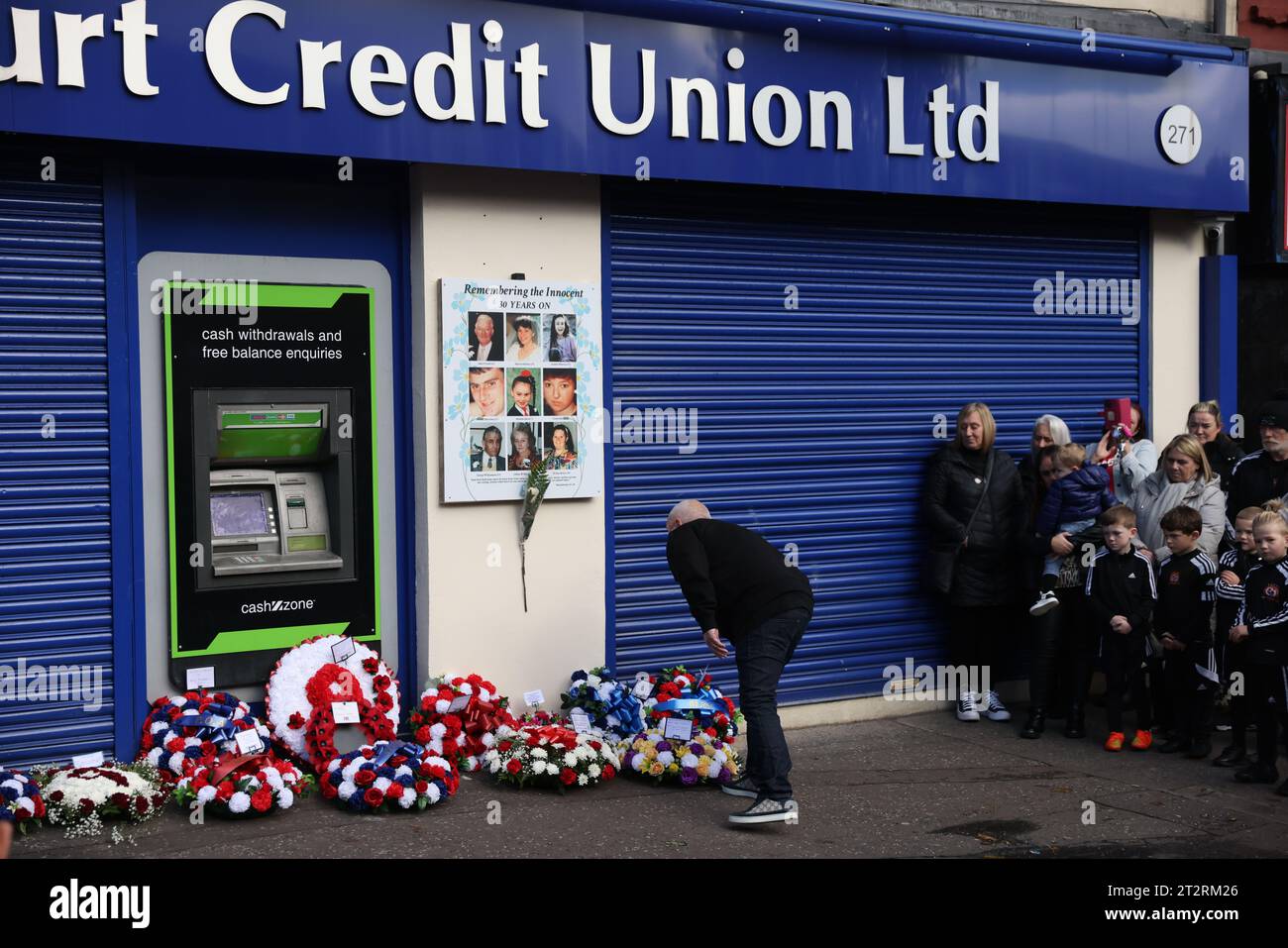 A person lays a wreath on Shankill Road in Belfast, during an event to ...