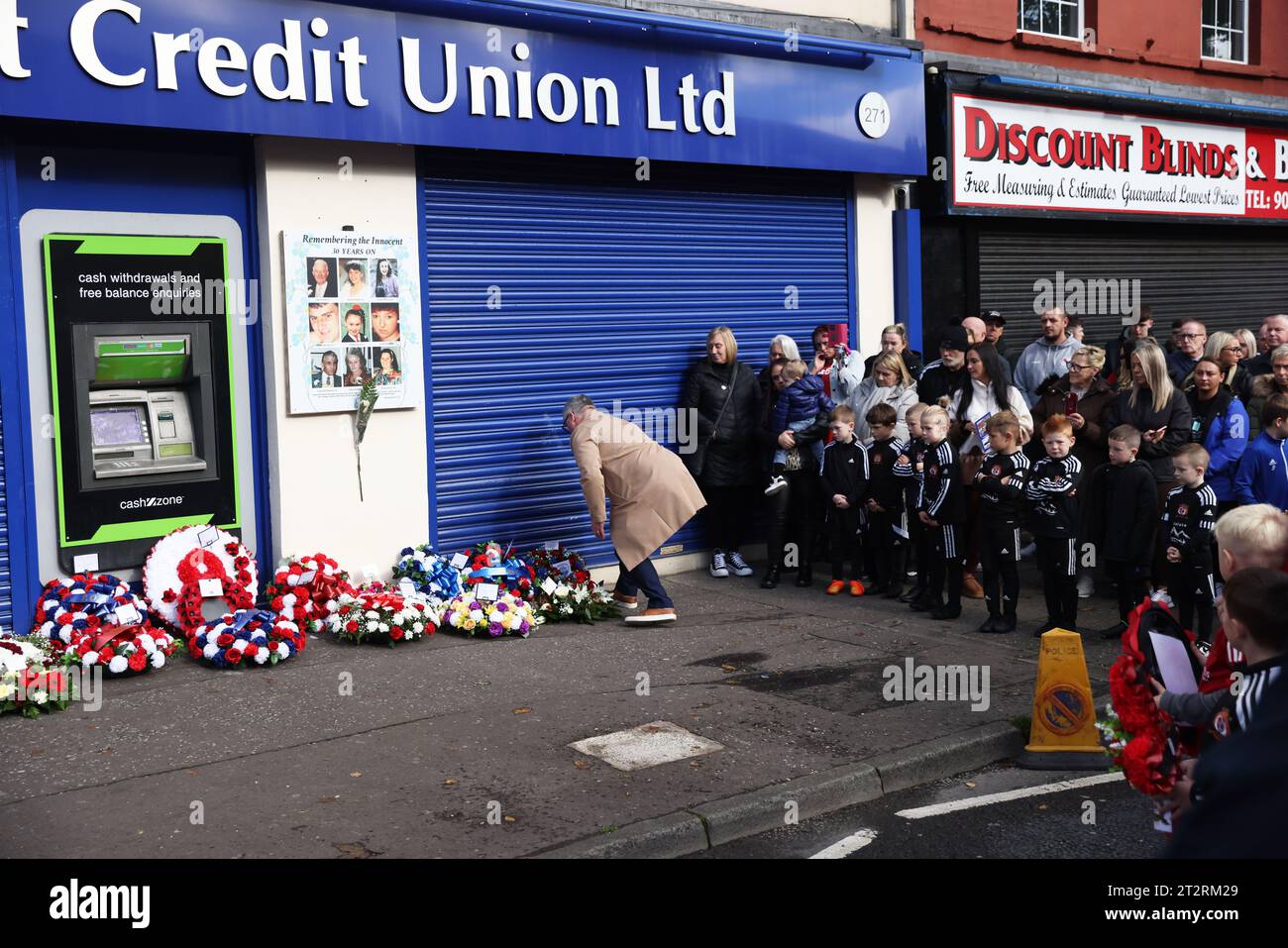 A person lays a wreath on Shankill Road in Belfast, during an event to ...