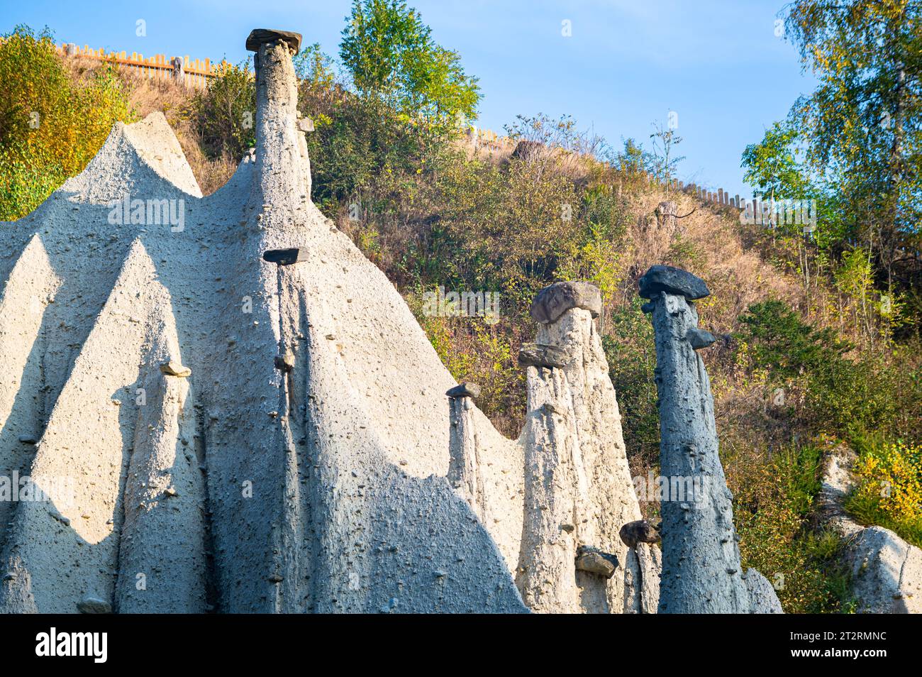 Stones on top of earth pyramids Stock Photo - Alamy