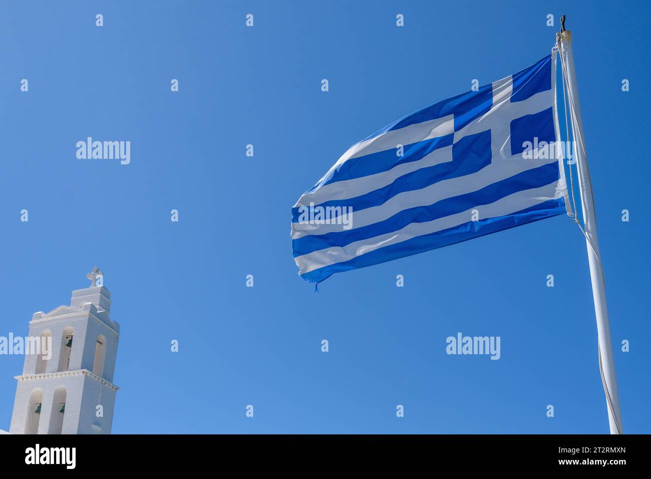 View of the national Greek flag and the top of a whitewashed Greek ...