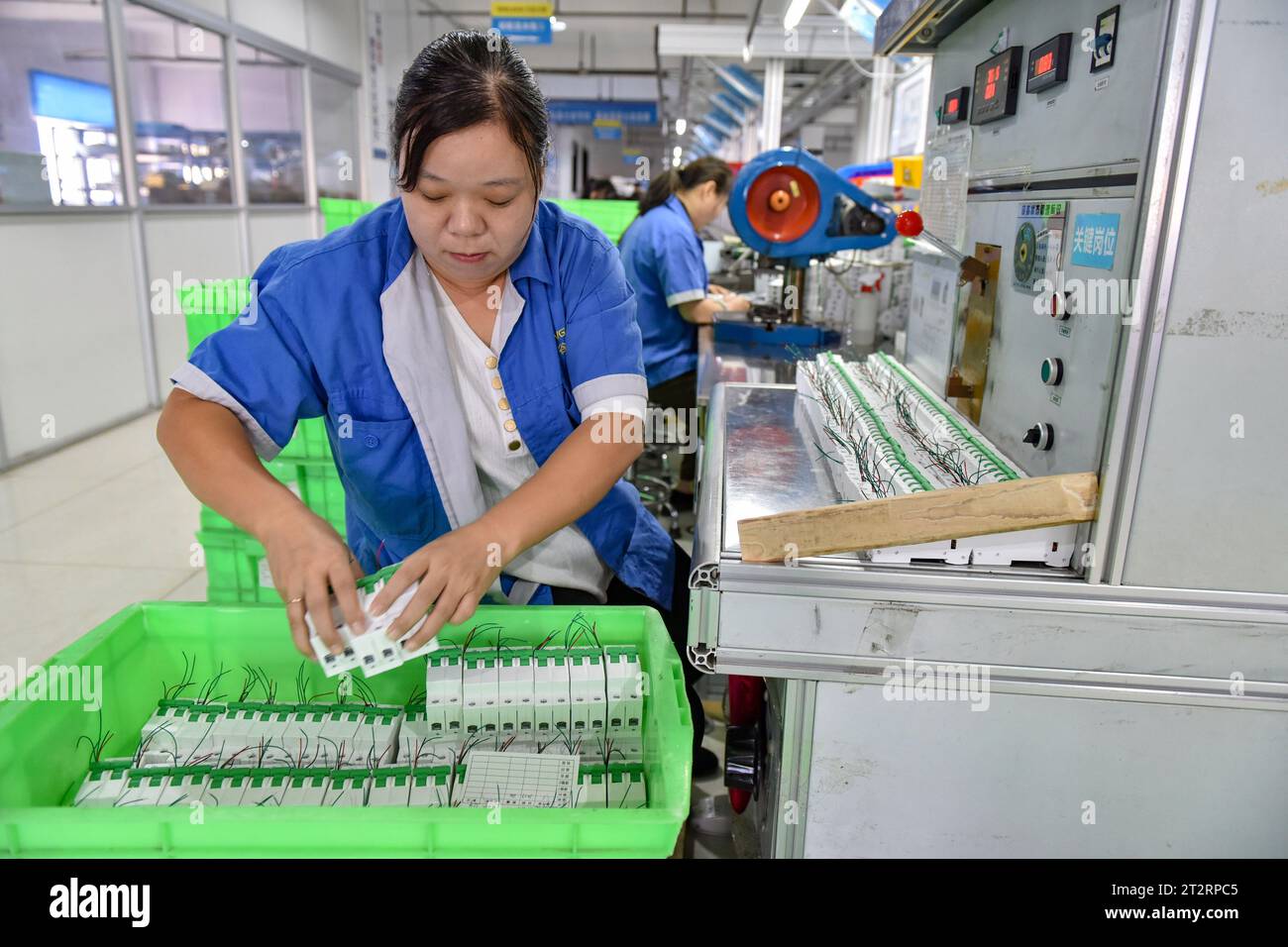 Fuyang, China. 18th Oct, 2023. Women wearing blue overalls work on the ...