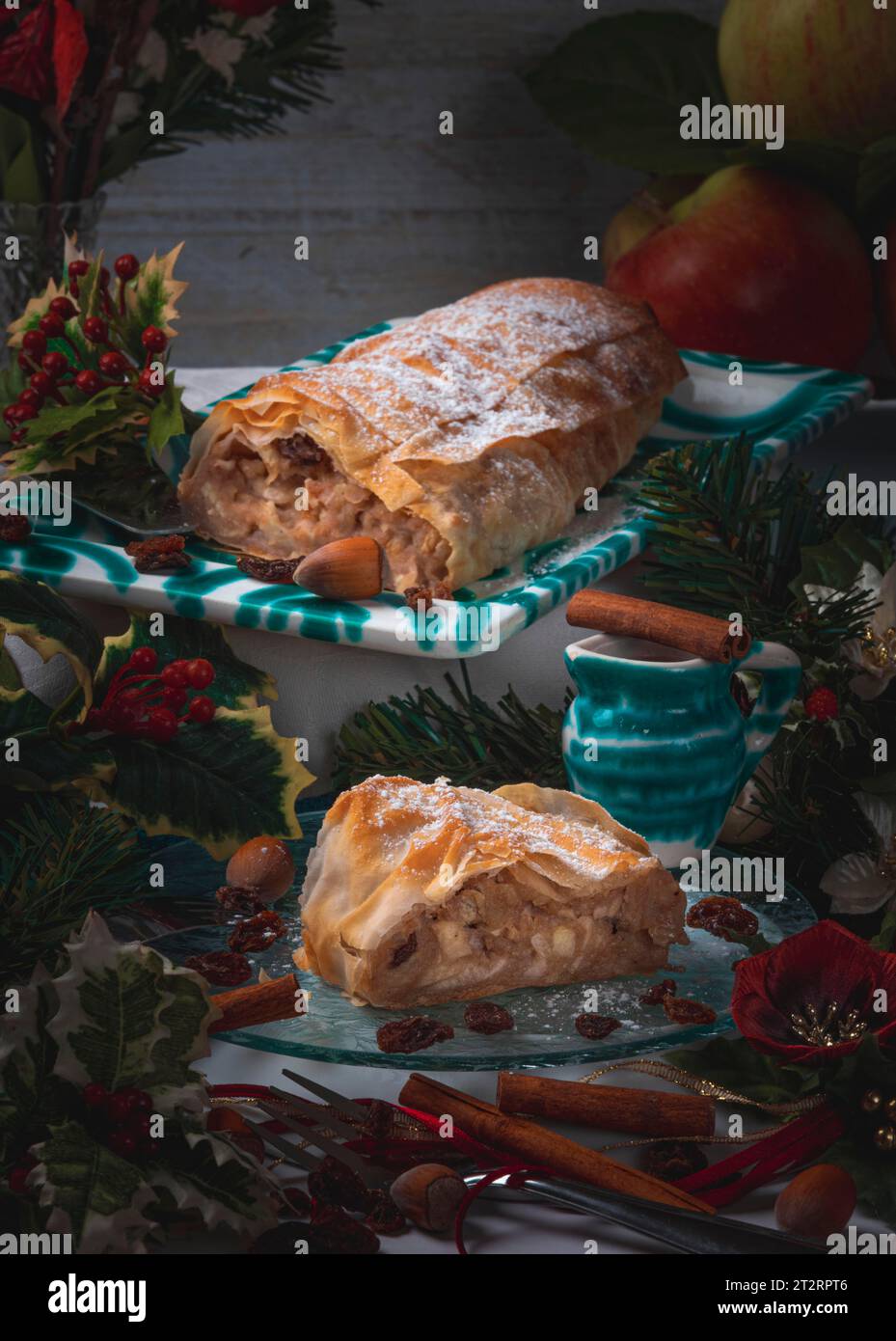 Homemade apple strudel, cut, table and background decorated for ...