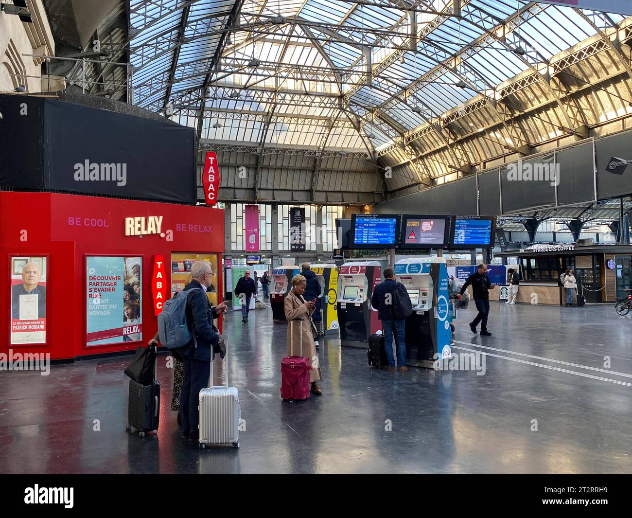 Travellers waiting in front of ticket counter, display board, Gare de l ...
