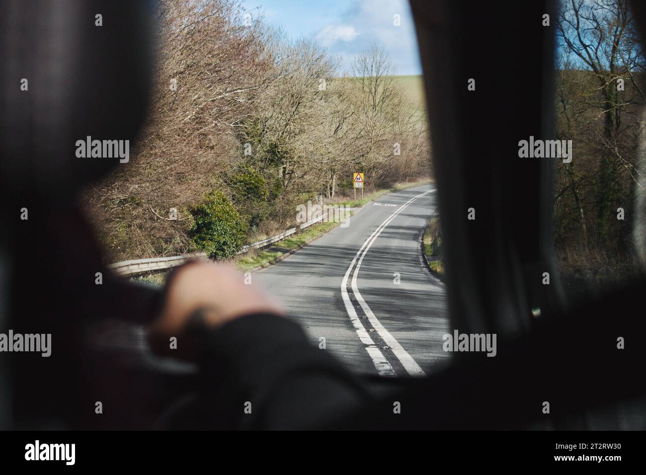 Rear passenger point of view from interior of car travelling, looking ...