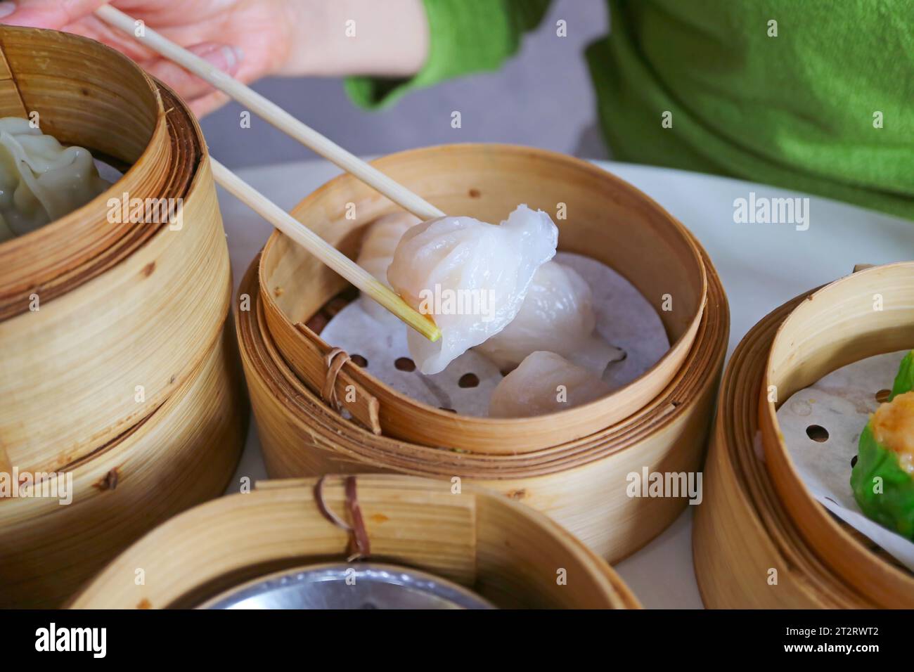 Hand Grabbing a Steamed Chinese Shrimp Dumplings Called Ha Gau with ...