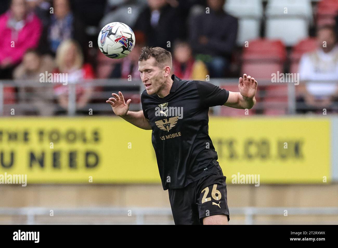 London, UK. 21st Oct, 2023. Jamie McCart #26 of Barnsley heads the ball ...