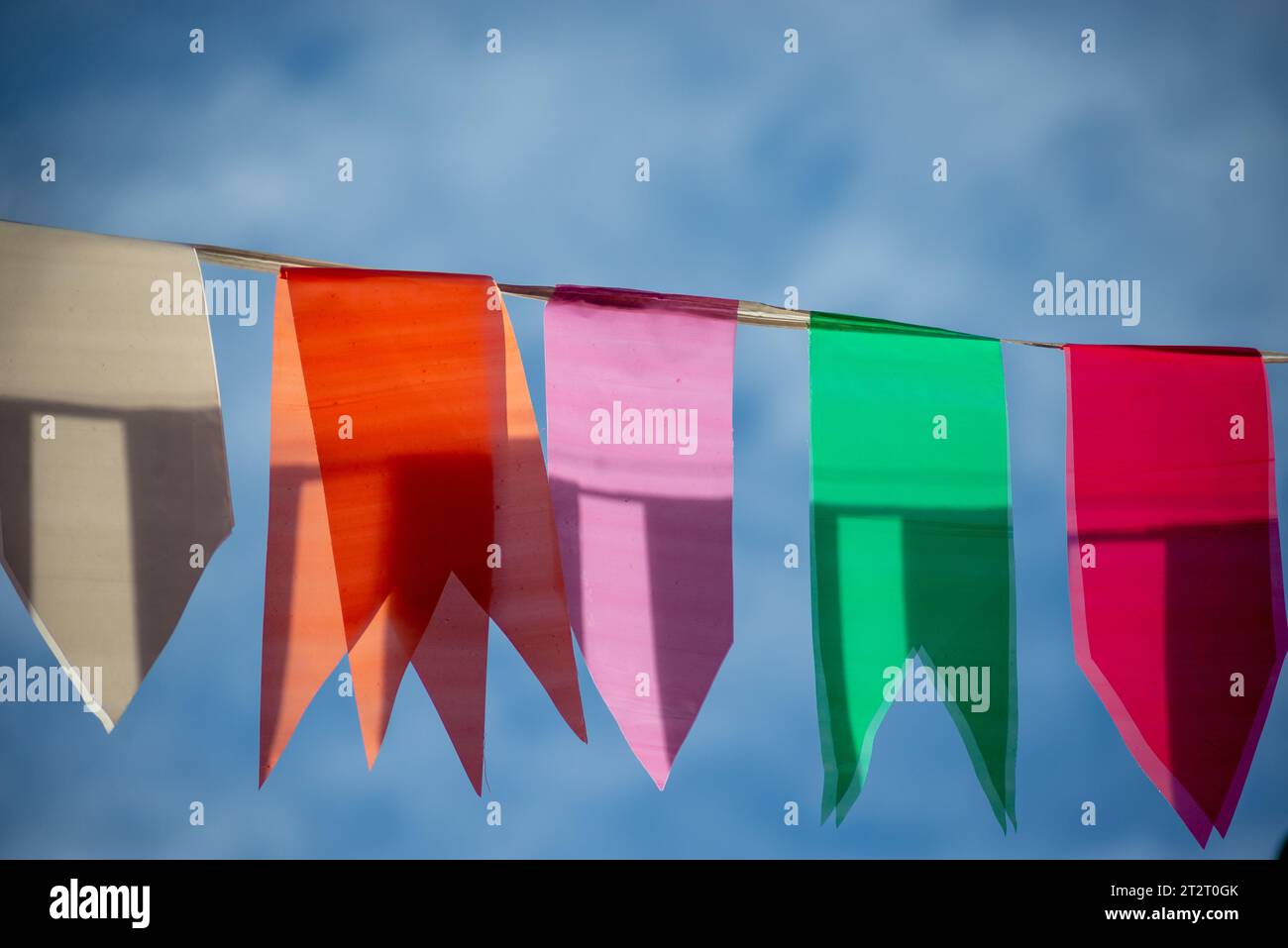 Festive decoration flags of different colors hanging with string ...