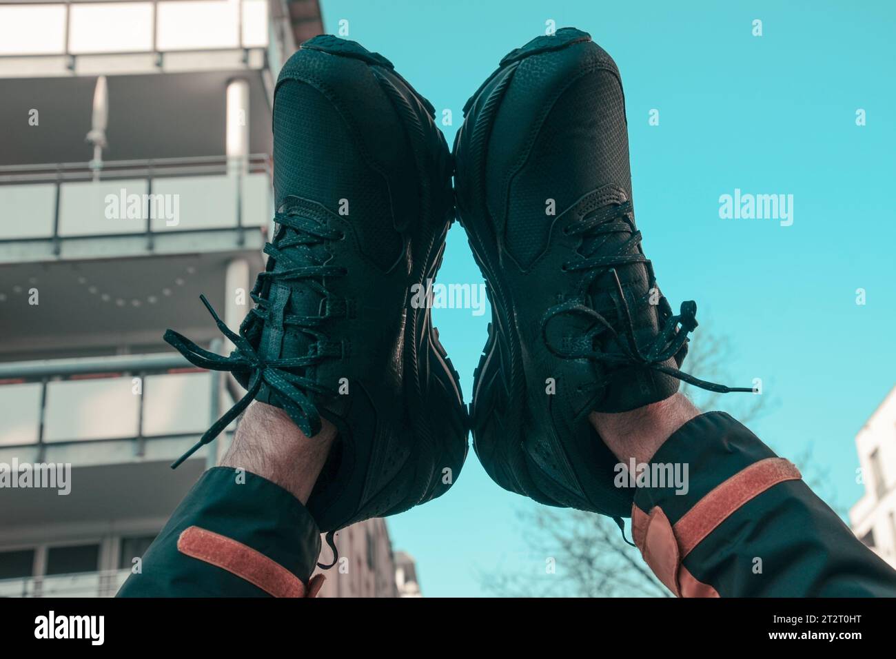 Black men's boots against sky background. The boots are worn on the ...