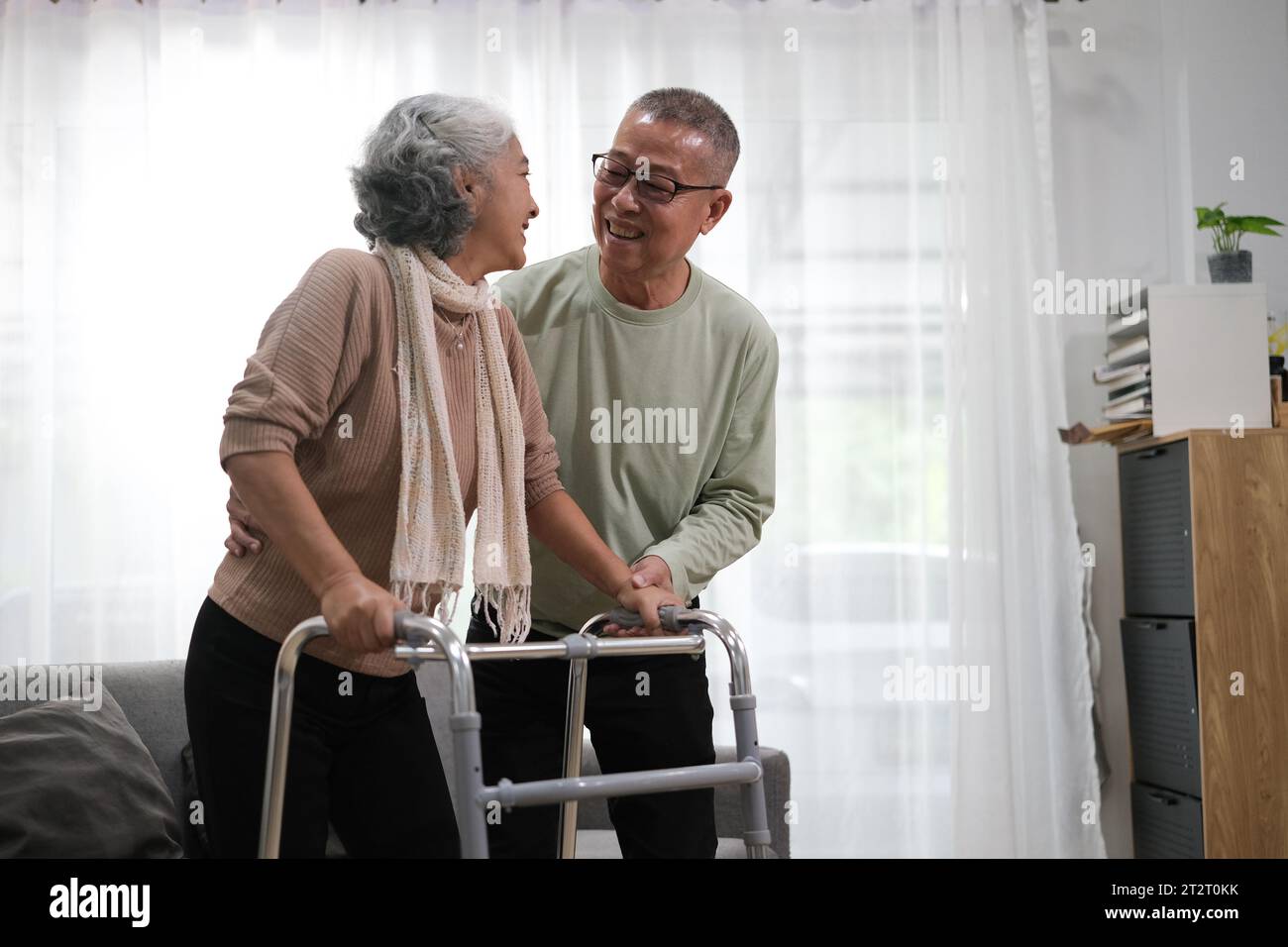Helping elderly disabled wife hi-res stock photography and images - Alamy