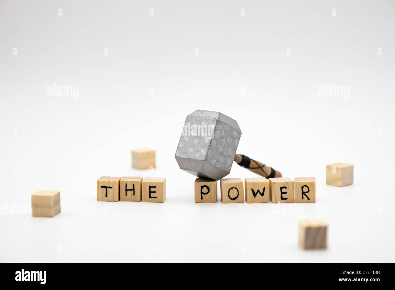 The wooden cubes with the words THE POWER and the weapon around against ...