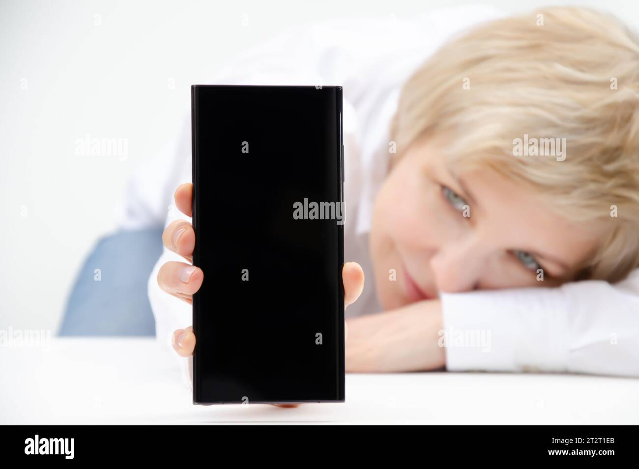 Woman is holding the smartphone with screen facing forward. Woman's ...