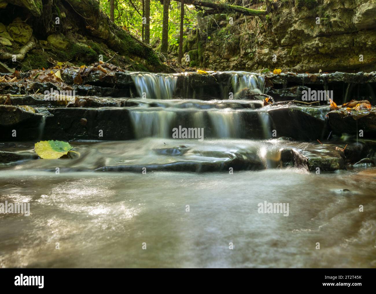 a small rapid river flows through dolomite rocks, long-term exposure ...