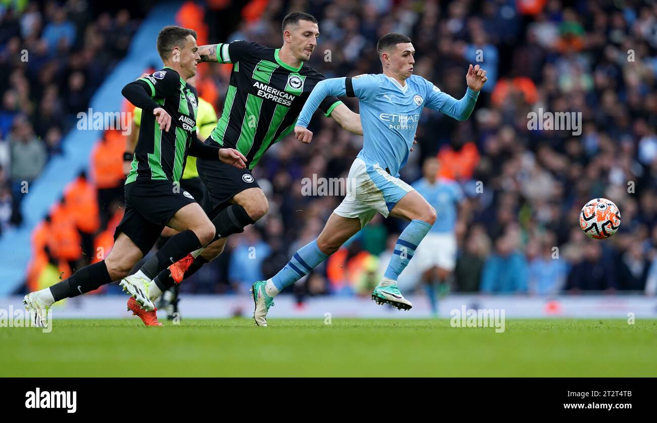 Manchester City's Phil Foden (right) skips away from Brighton and Hove ...
