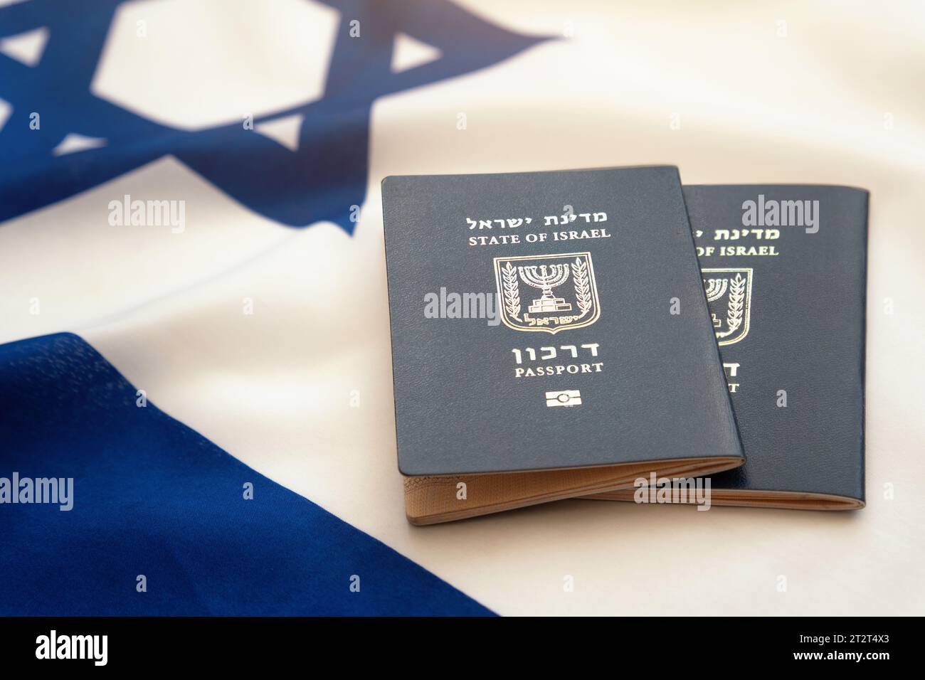 Two Israeli international passports lie on the Israeli flag with solar ... Two Israeli international passports lie on the Israeli flag with solar ...