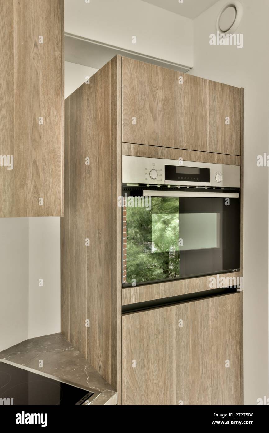 the inside of a kitchen with wood cabinets and an oven in it's center ...