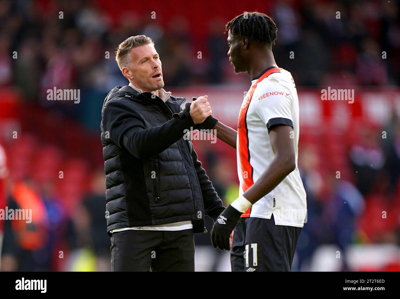 Luton Town manager Rob Edwards speaks to Elijah Adebayo at the end of ...