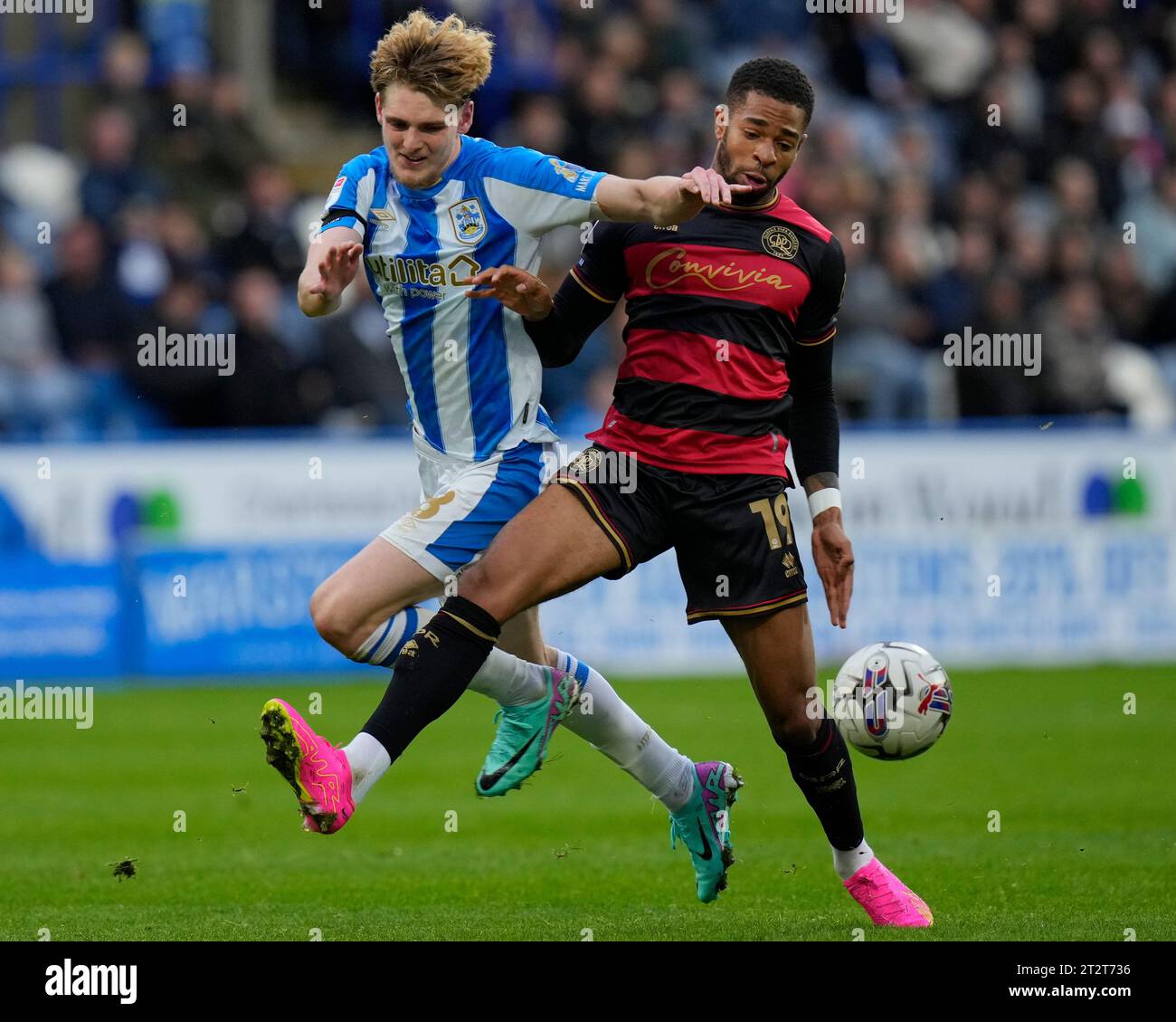 Jack Rudoni #8 of Huddersfield Town competes for the ball with Elijah ...