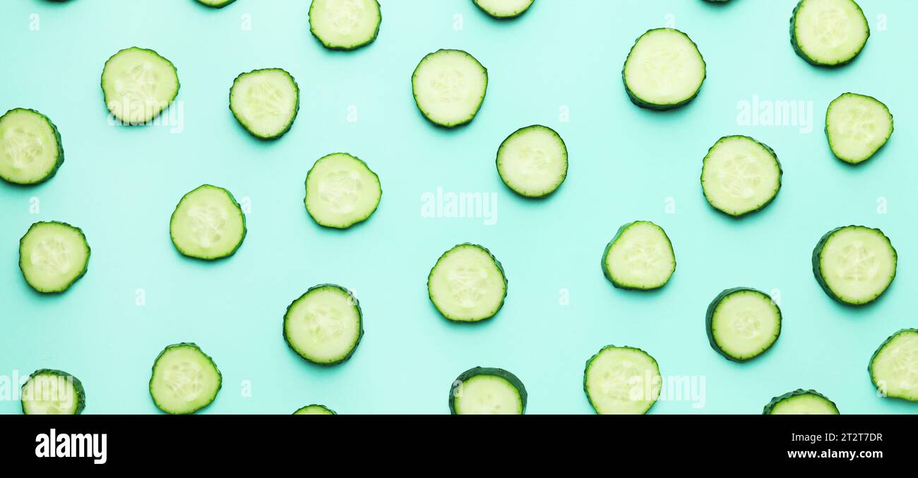 Many sliced cucumbers on light blue background, top view Stock Photo ...