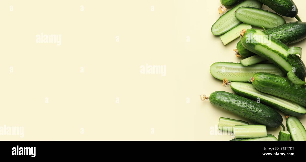 Many cucumbers on light beige background with space for text, top view ...