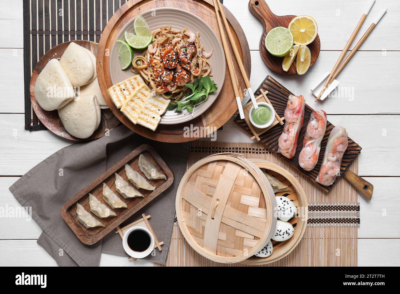 Composition with different Chinese dishes and chopsticks on light ...
