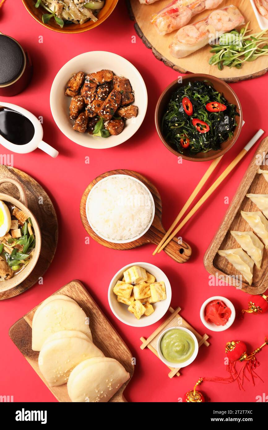 Composition with delicious Chinese dishes on red background Stock Photo ...