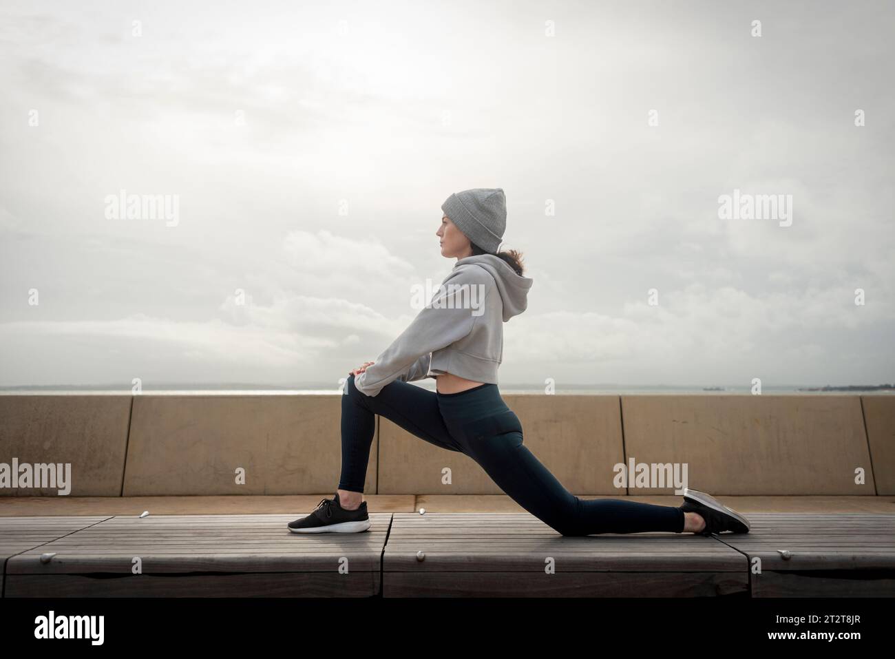 Sportswoman doing lunge hamstring stretch hi-res stock photography and ...