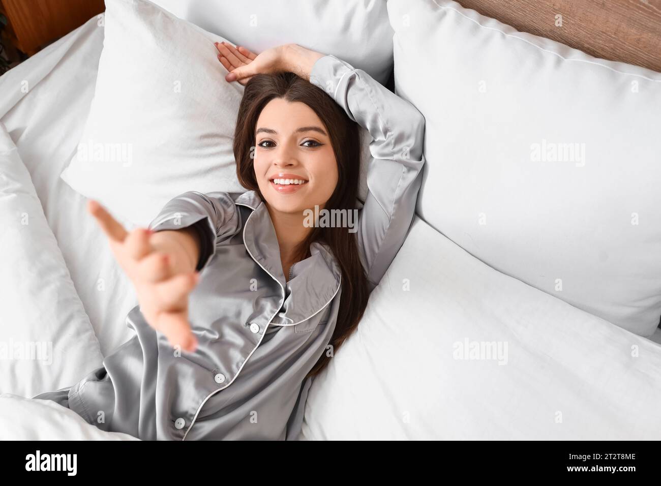 Young woman lying in bed Stock Photo - Alamy