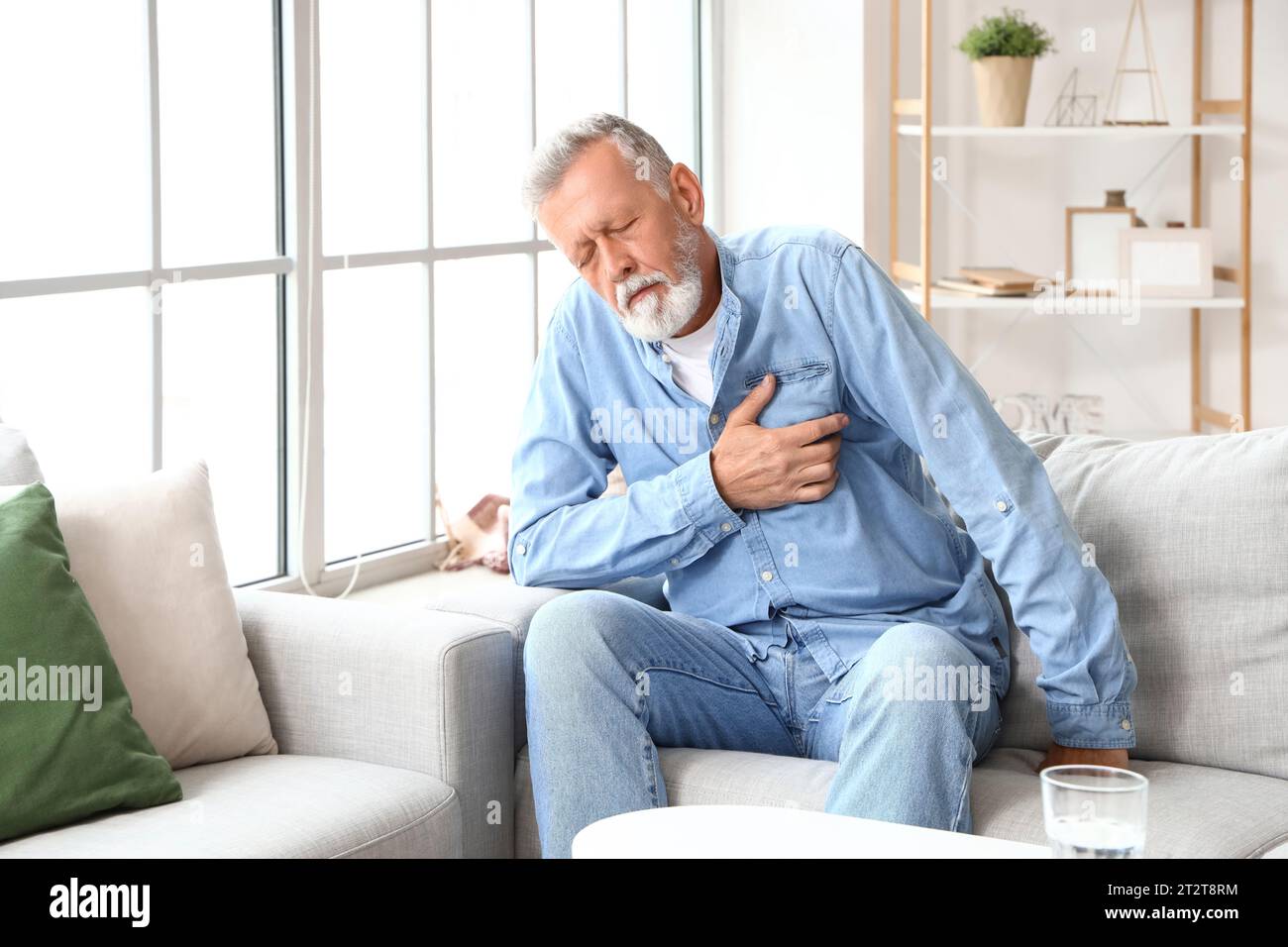 Mature man having heart attack at home Stock Photo - Alamy