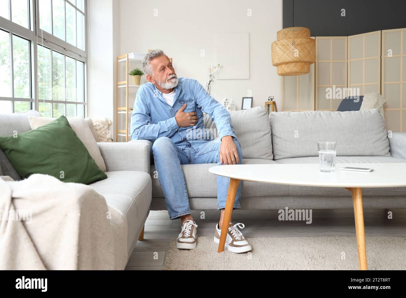 Mature man having heart attack at home Stock Photo - Alamy