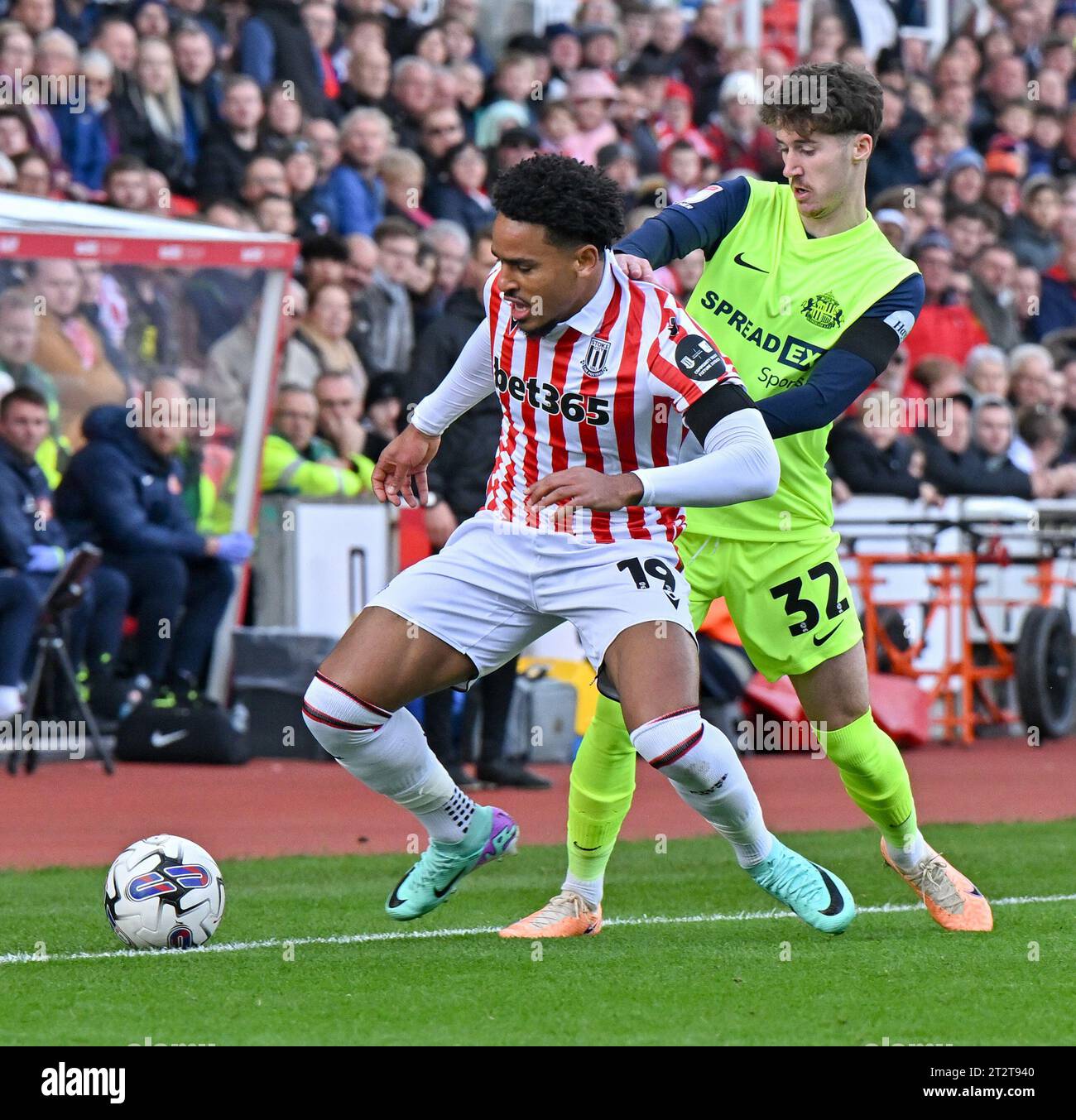 Ryan Mmaee 19# of Stoke City Football Club and Trai Hume 32# of ...