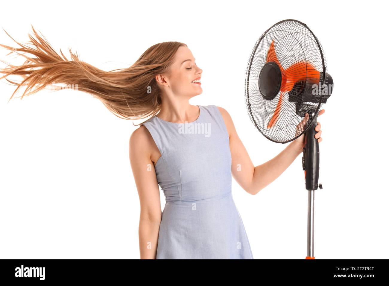 Young woman with electric fan on white background Stock Photo - Alamy