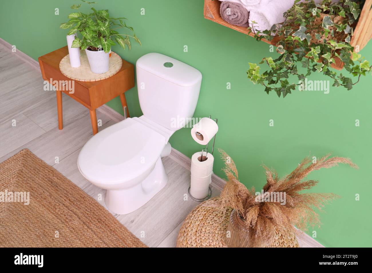 Interior of restroom with toilet bowl and table Stock Photo - Alamy