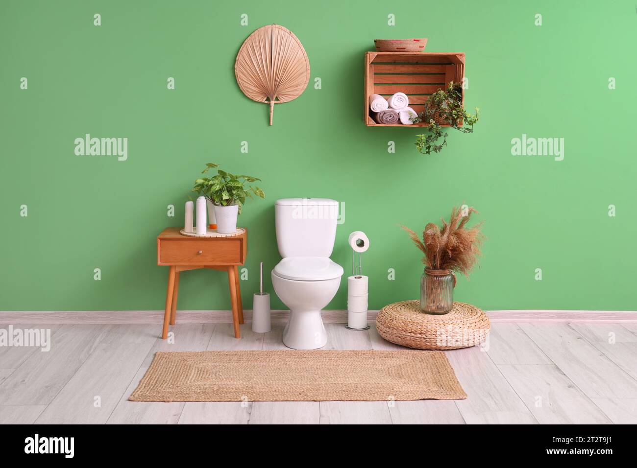 Interior of restroom with toilet bowl and table Stock Photo - Alamy