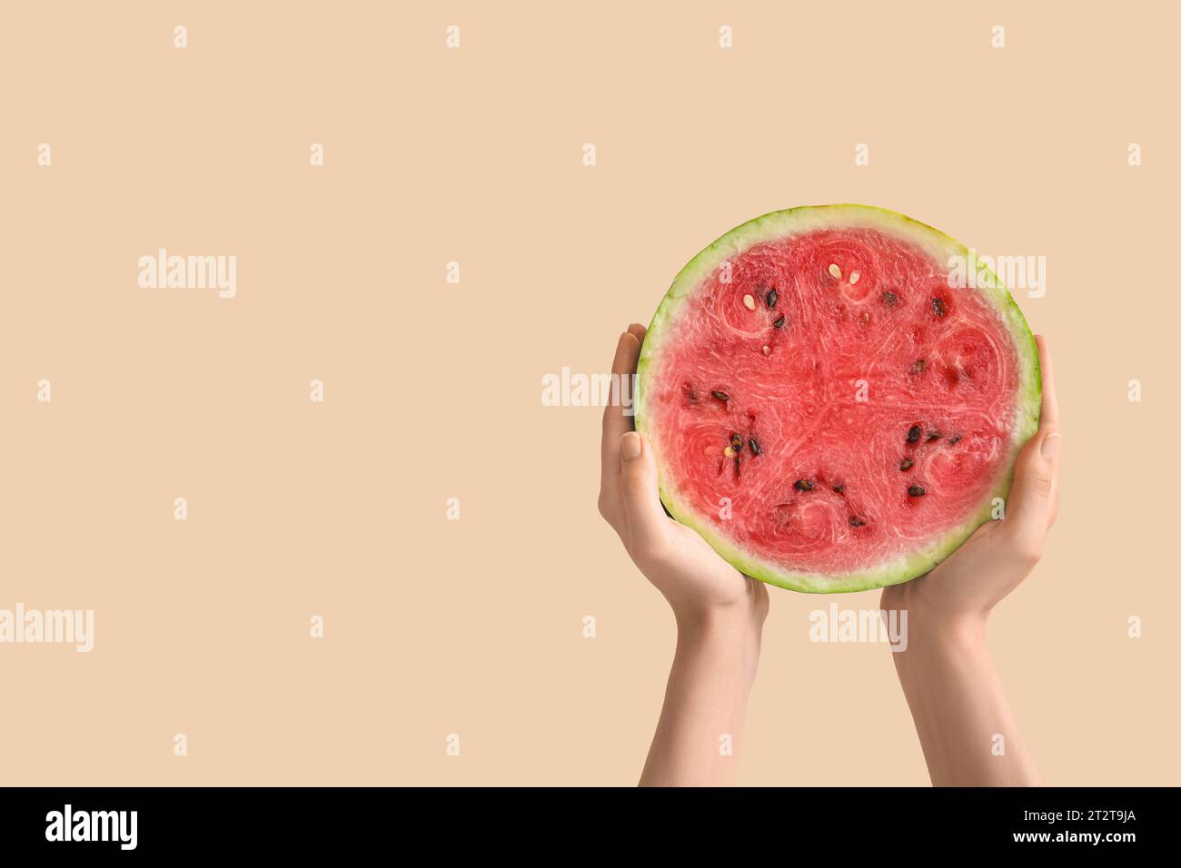 Female hands with half of ripe watermelon on beige background Stock ...