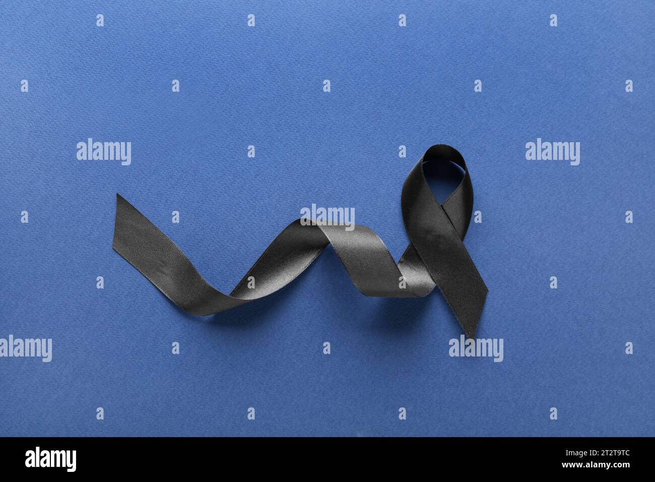 Black funeral ribbon on blue background Stock Photo - Alamy