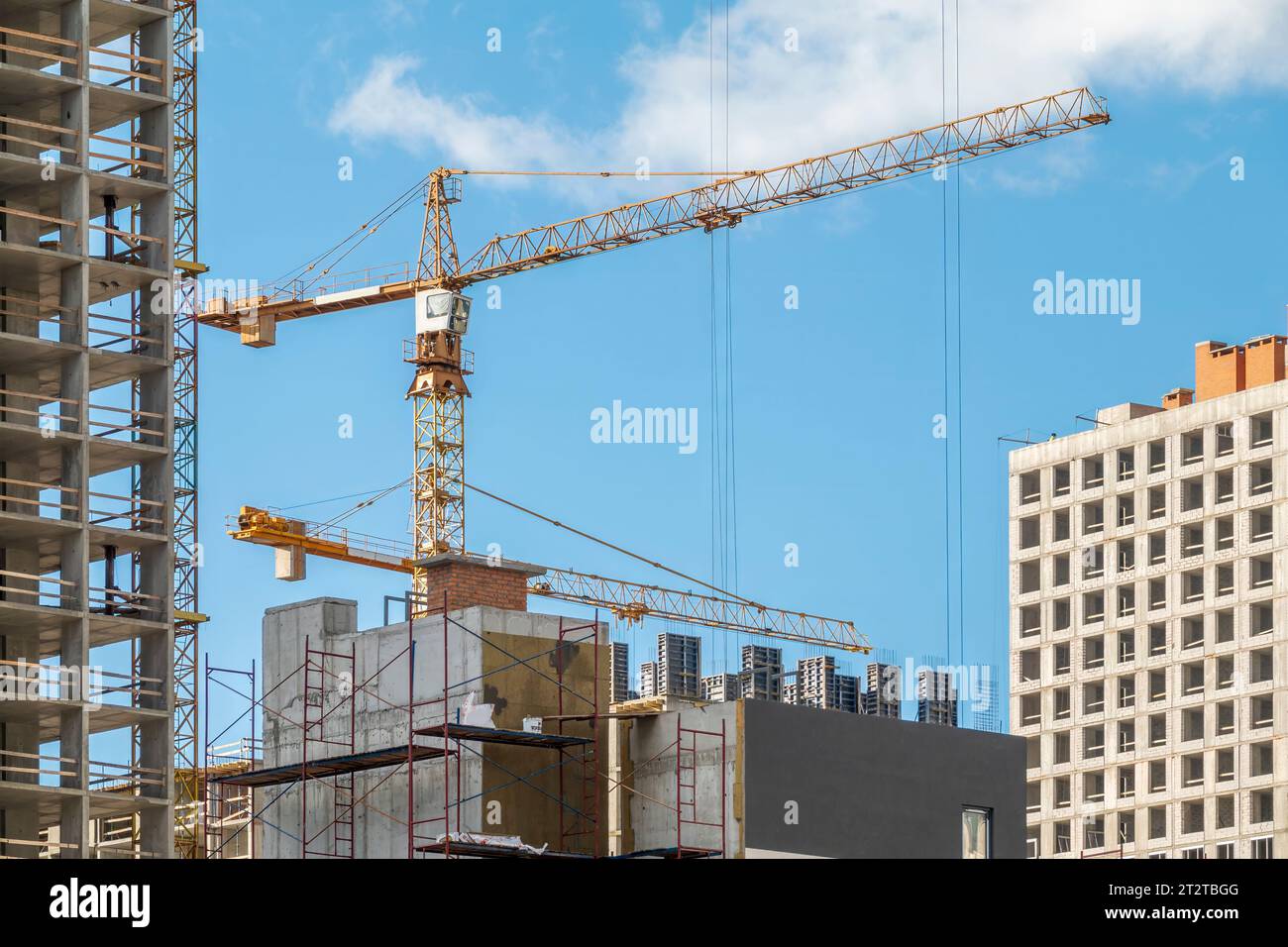 Crane, concrete blocks and scaffolding on the construction site Stock ...