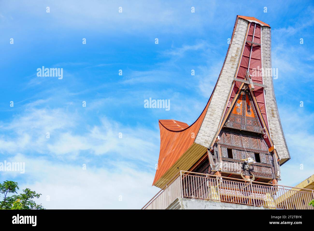 Authentic tana toraja architecture replica against gorgeous blue sky ...