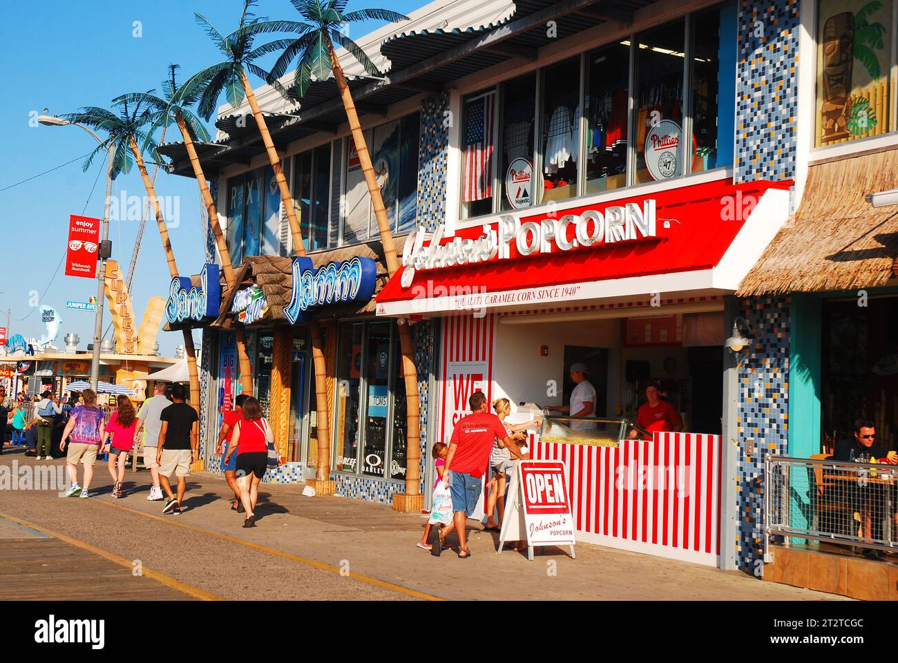 People enjoy a walk on the boardwalk on the Jersey Shore town of Wildwood on a summer vacation ...