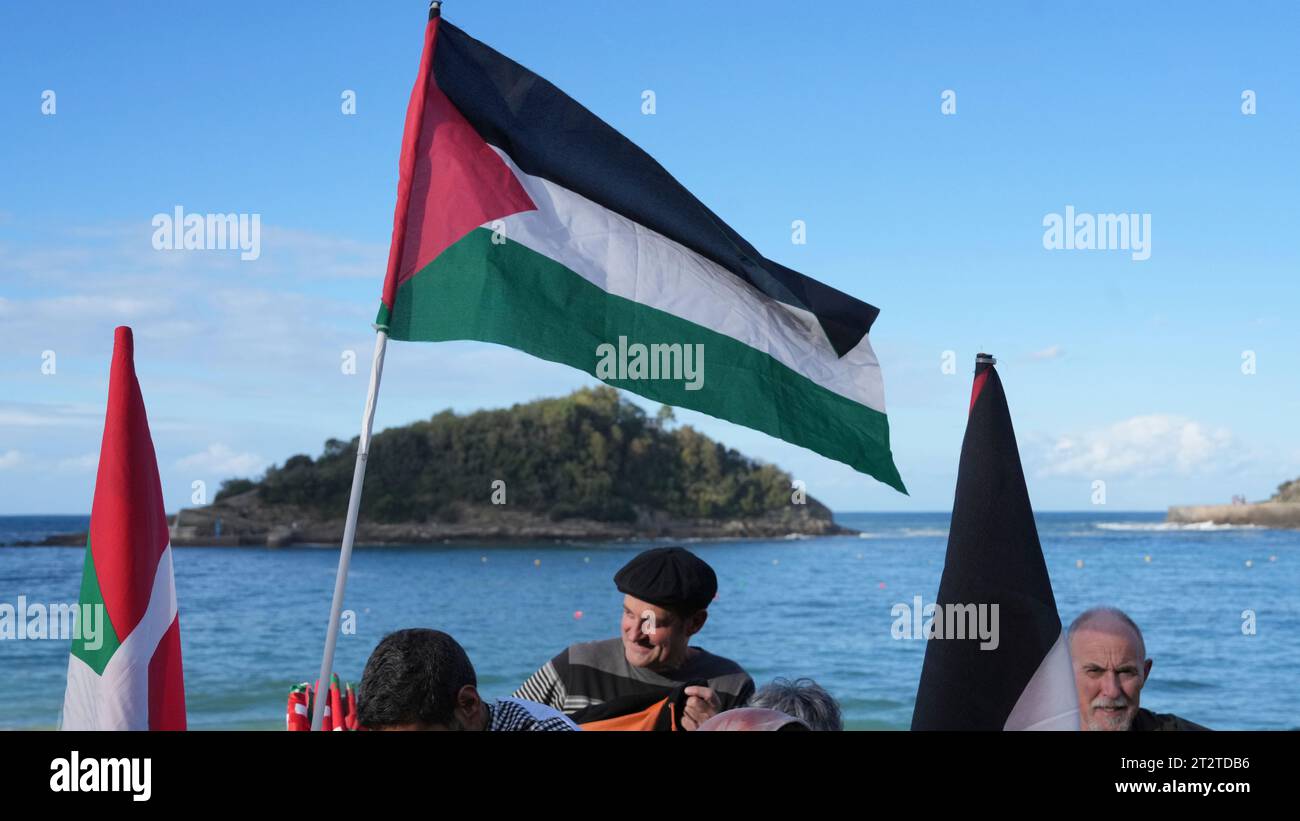 Several people carrying flags during a protest in solidarity with the ...
