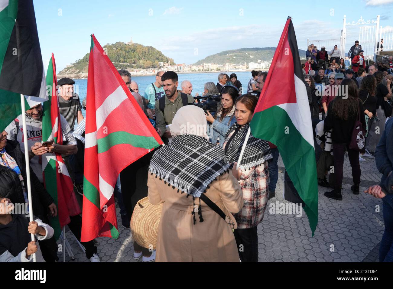 Several people carrying flags during a protest in solidarity with the ...