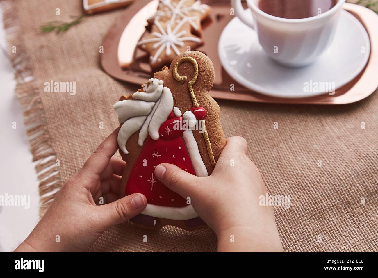 Bitten gingerbread homemade cookie of Saint Nicholas in child's hands ...