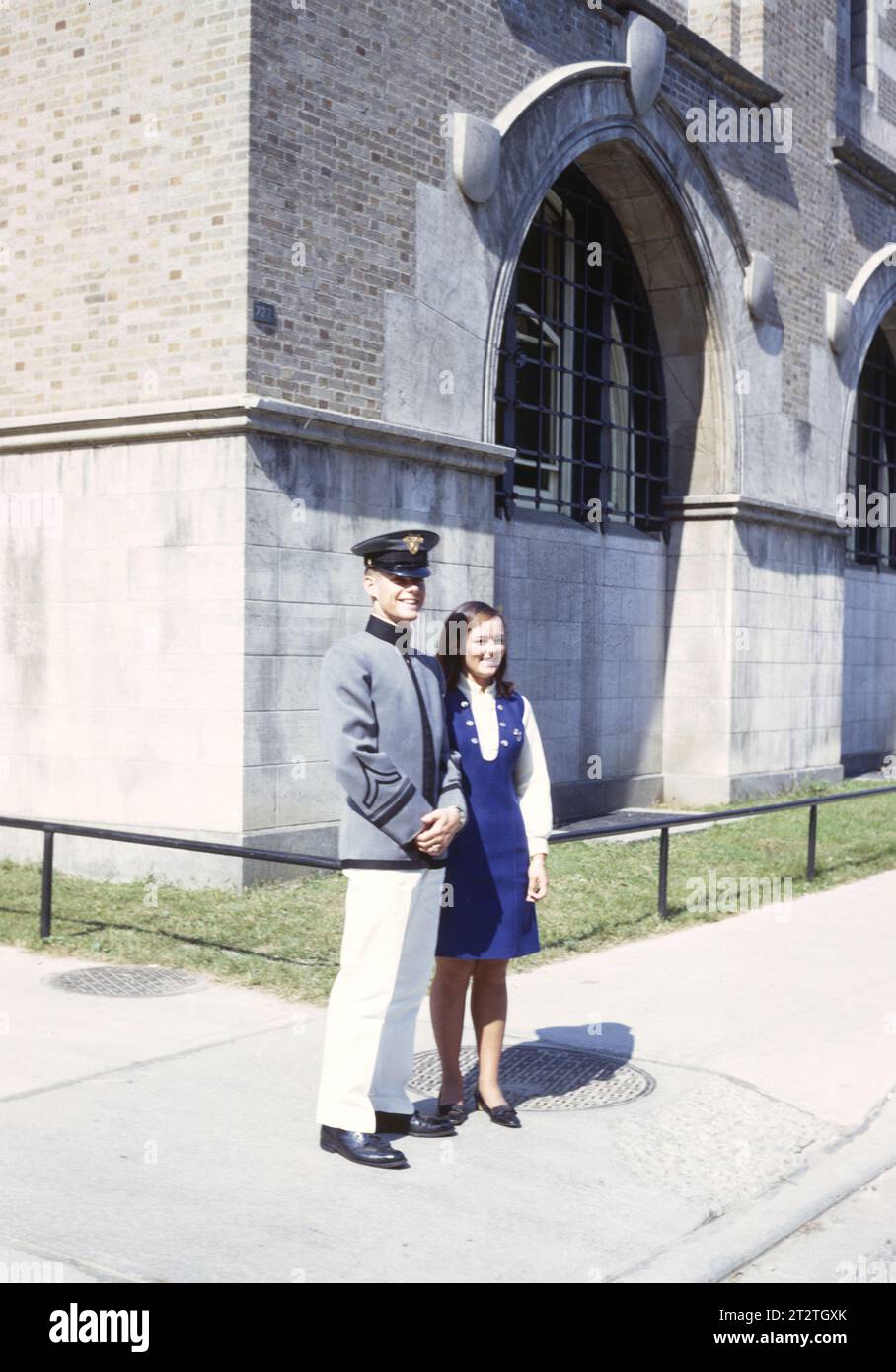 A West Point cadet in dress gray uniform, escorts his date on an autumn ...