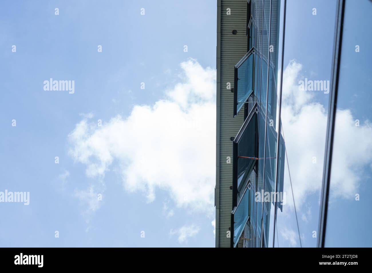 Stunning low-angle shot of an open high-rise building window, framed by ...