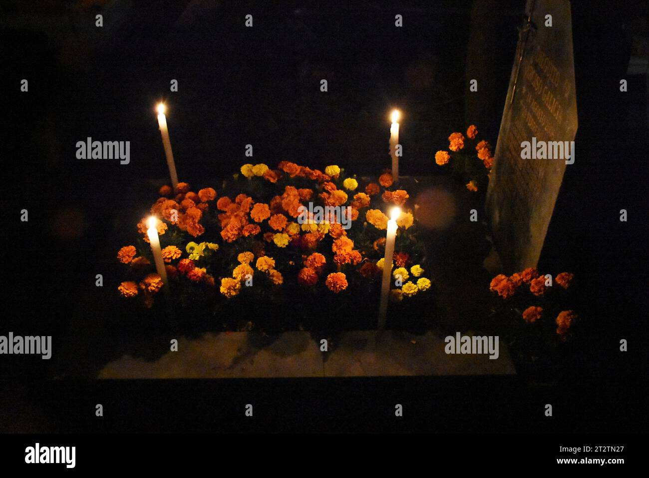 Decorated graves at night during Day of the Dead in San Gregorio ...