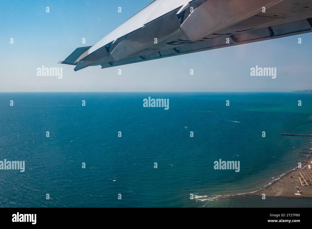 Azure waves of the sea under the wing of a flying plane Stock Photo - Alamy