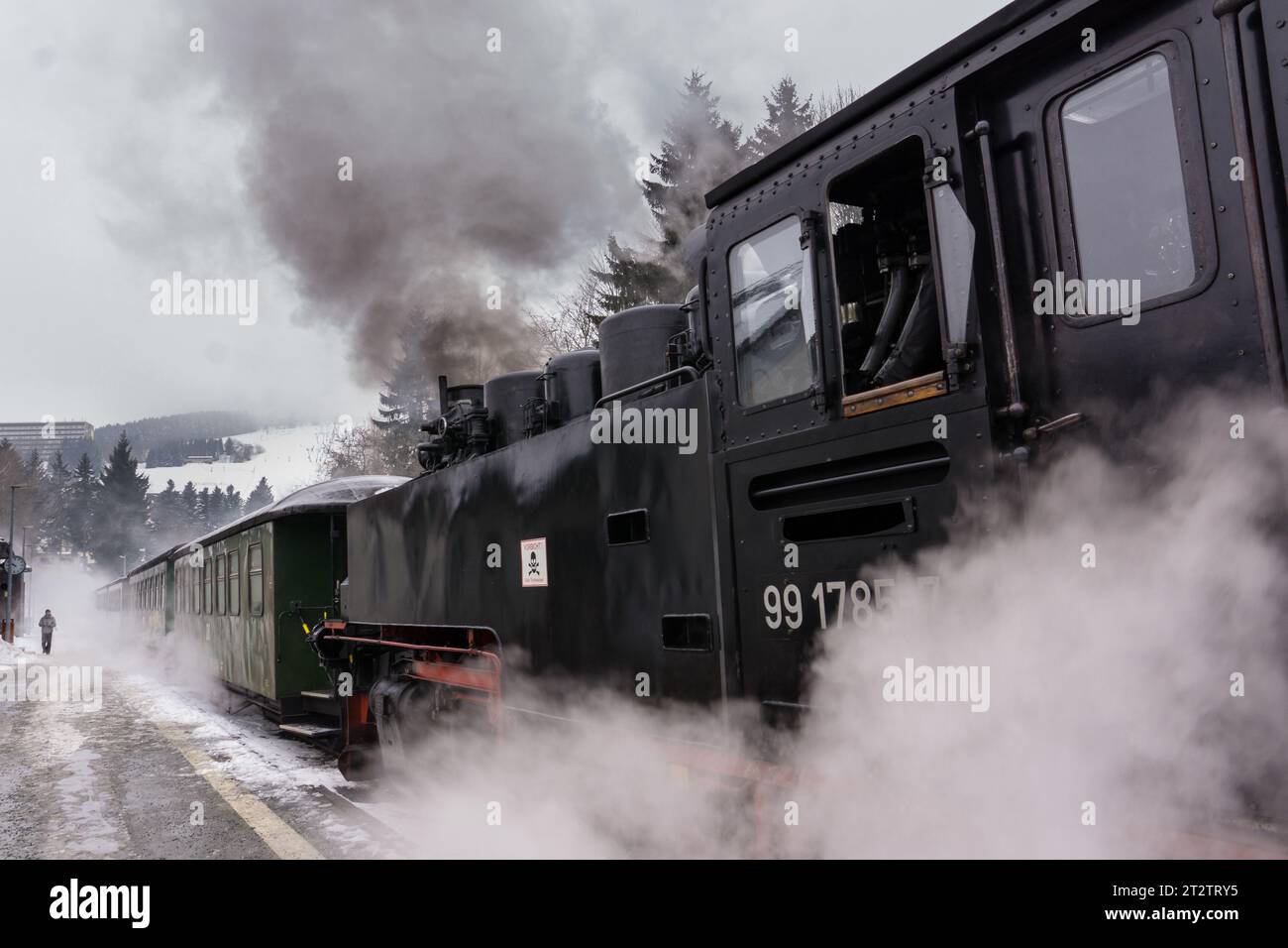 A vintage steam locomotive chugging down a set of railroad tracks ...